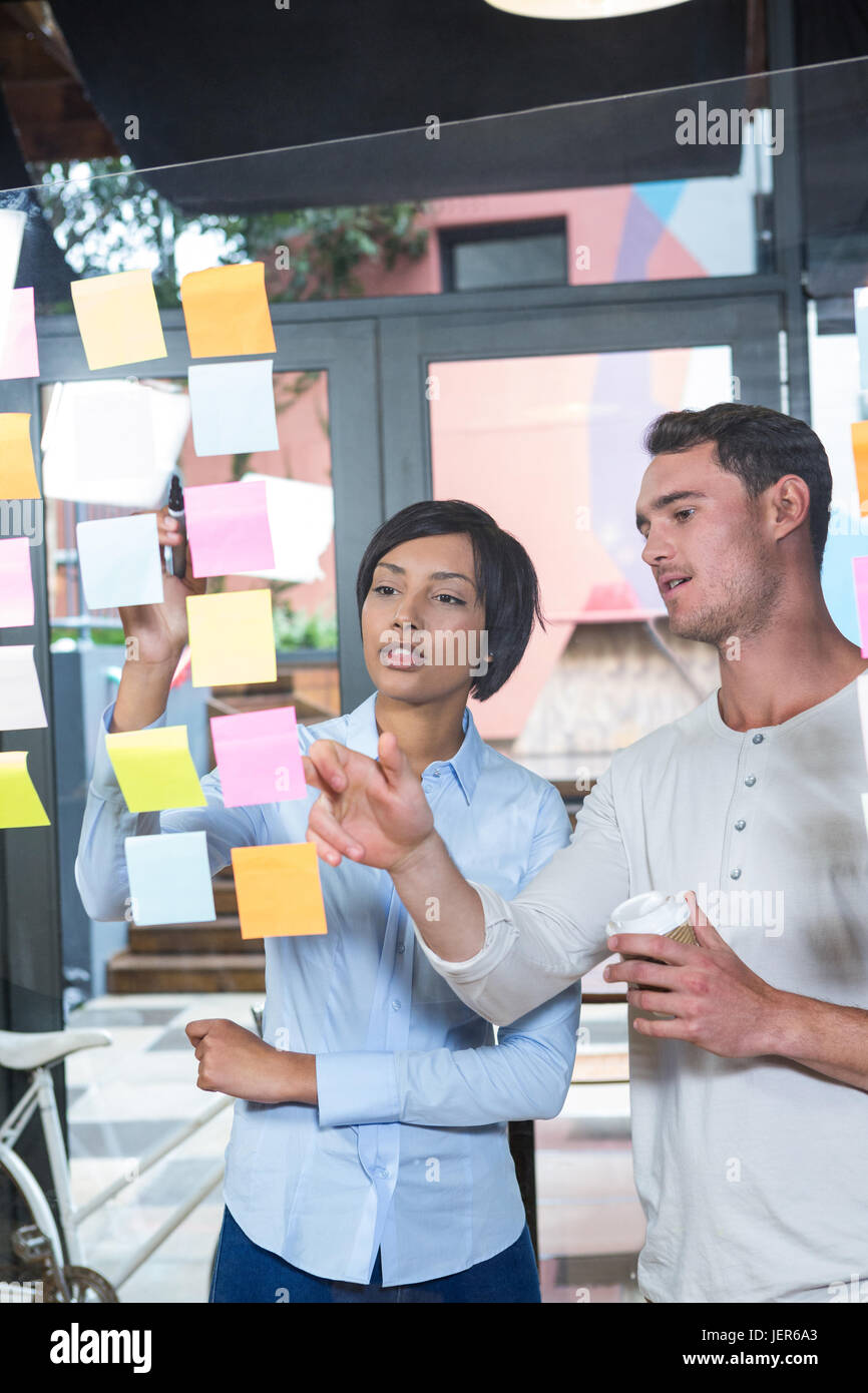 Colleagues looking at sticky notes Stock Photo - Alamy