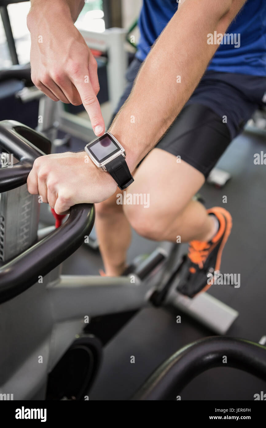 Man using smart watch while exercising Stock Photo - Alamy