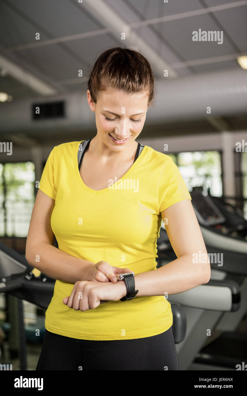 Woman using smart watch on treadmill Stock Photo - Alamy