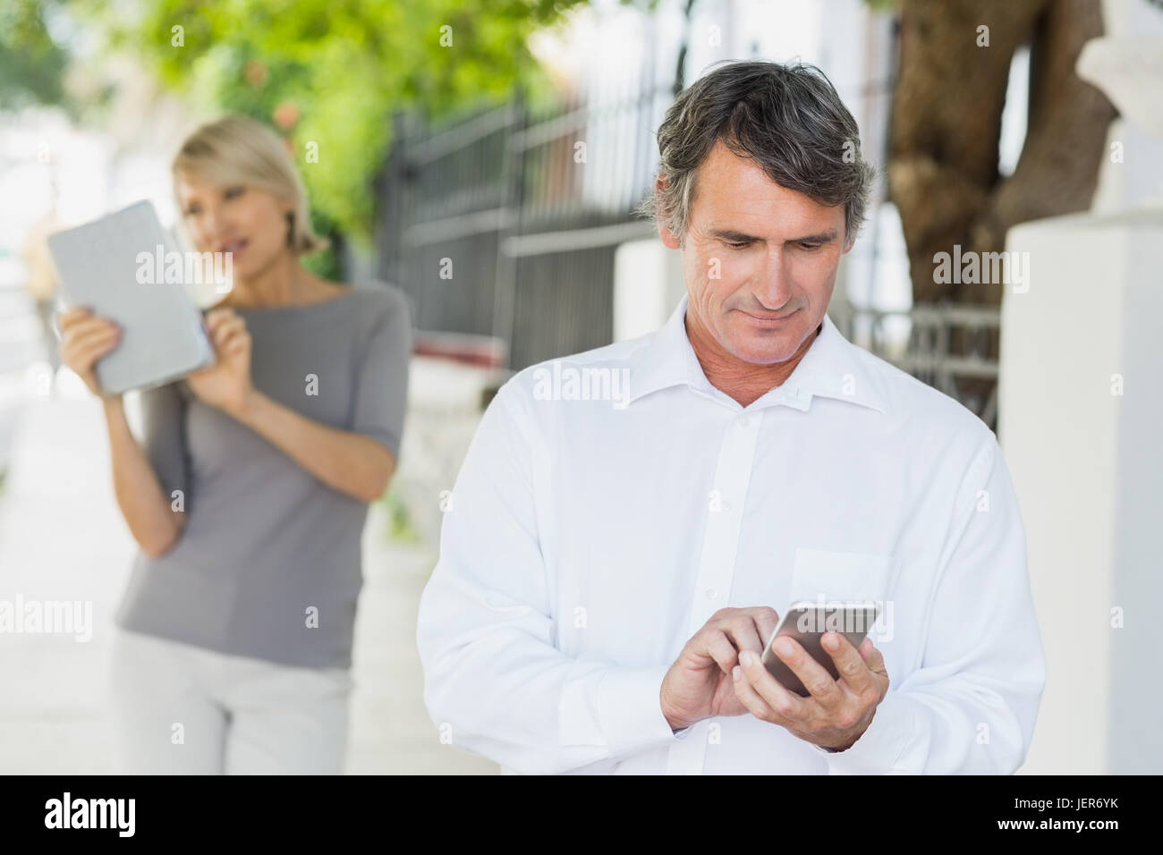 Couple using wireless technologies Stock Photo - Alamy