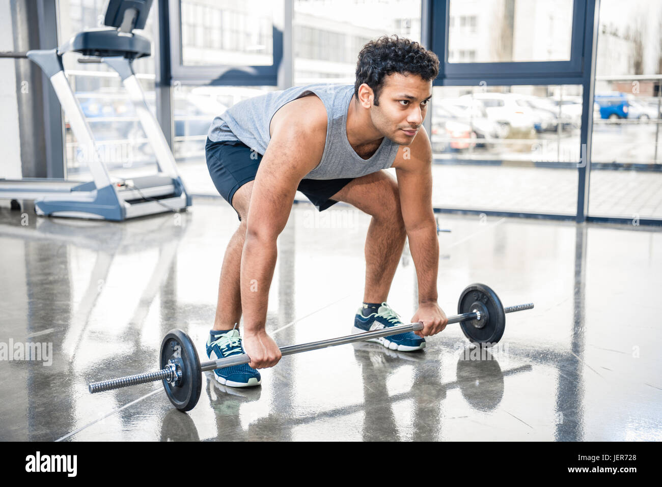 Handsome young man workout with barbell at gym Stock Photo - Alamy