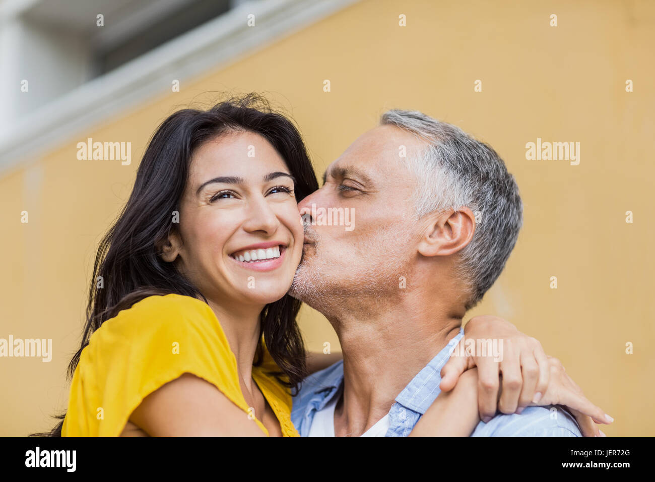 Close-up of man kissing happy woman Stock Photo - Alamy