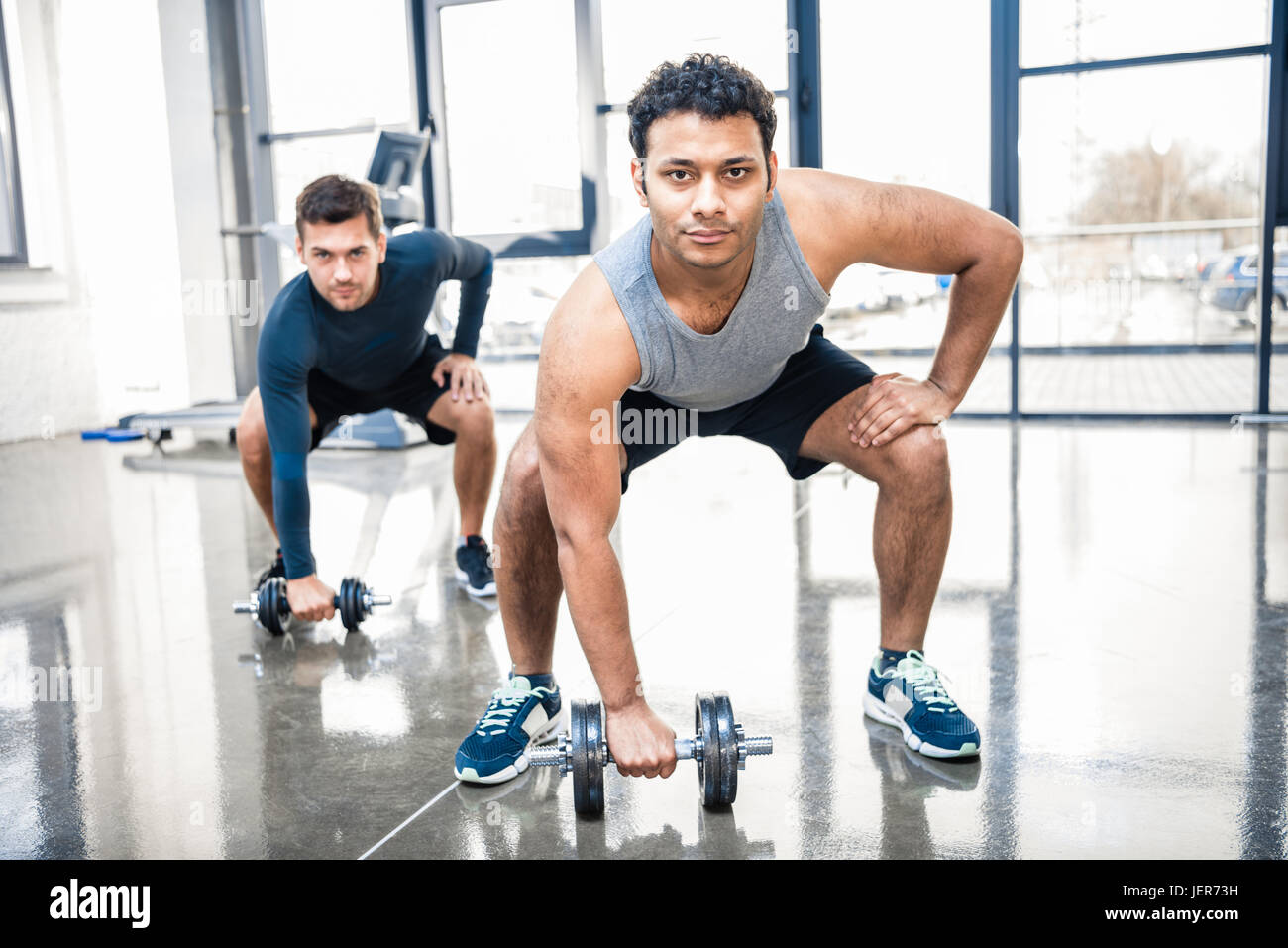 young men workout with dumbbells at gym Stock Photo - Alamy