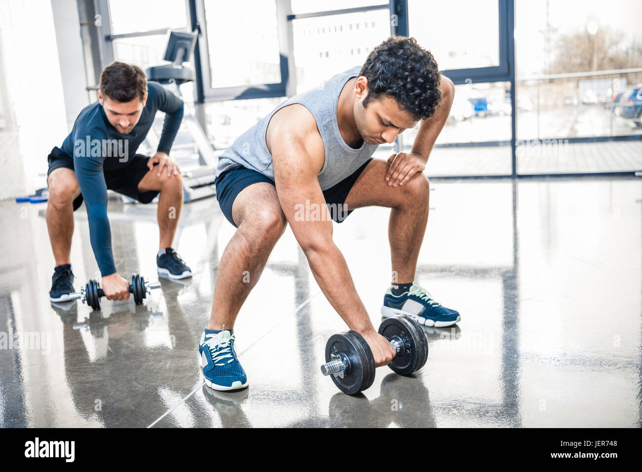 young men workout with dumbbells at gym Stock Photo - Alamy