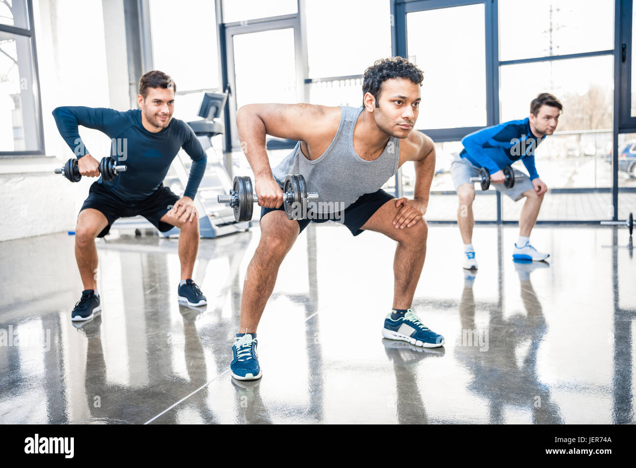 young men workout with dumbbells at gym Stock Photo - Alamy
