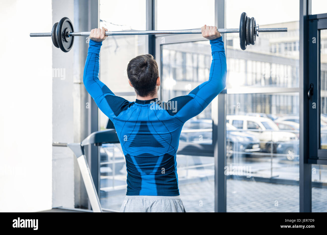Handsome young man workout with barbell at gym Stock Photo - Alamy