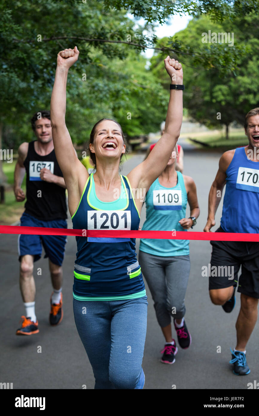Female athlete crossing finish line hi-res stock photography and images ...