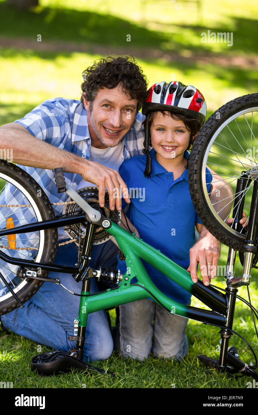 Father and son fixing the bike Stock Photo - Alamy
