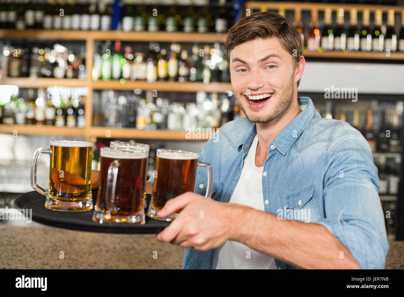 Man serving beers Stock Photo - Alamy