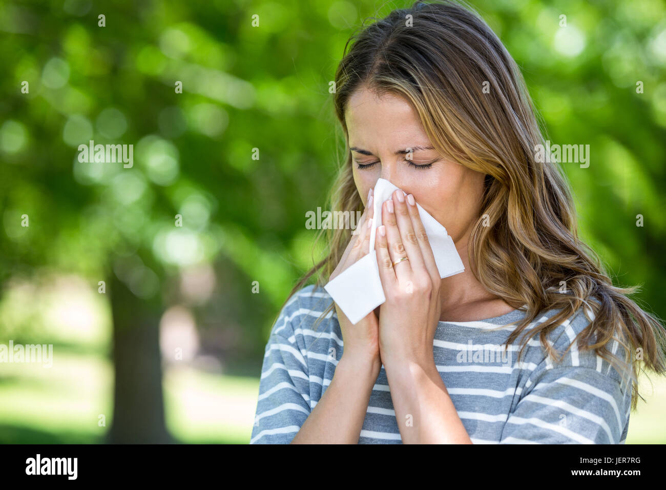 Woman using a tissue Stock Photo - Alamy
