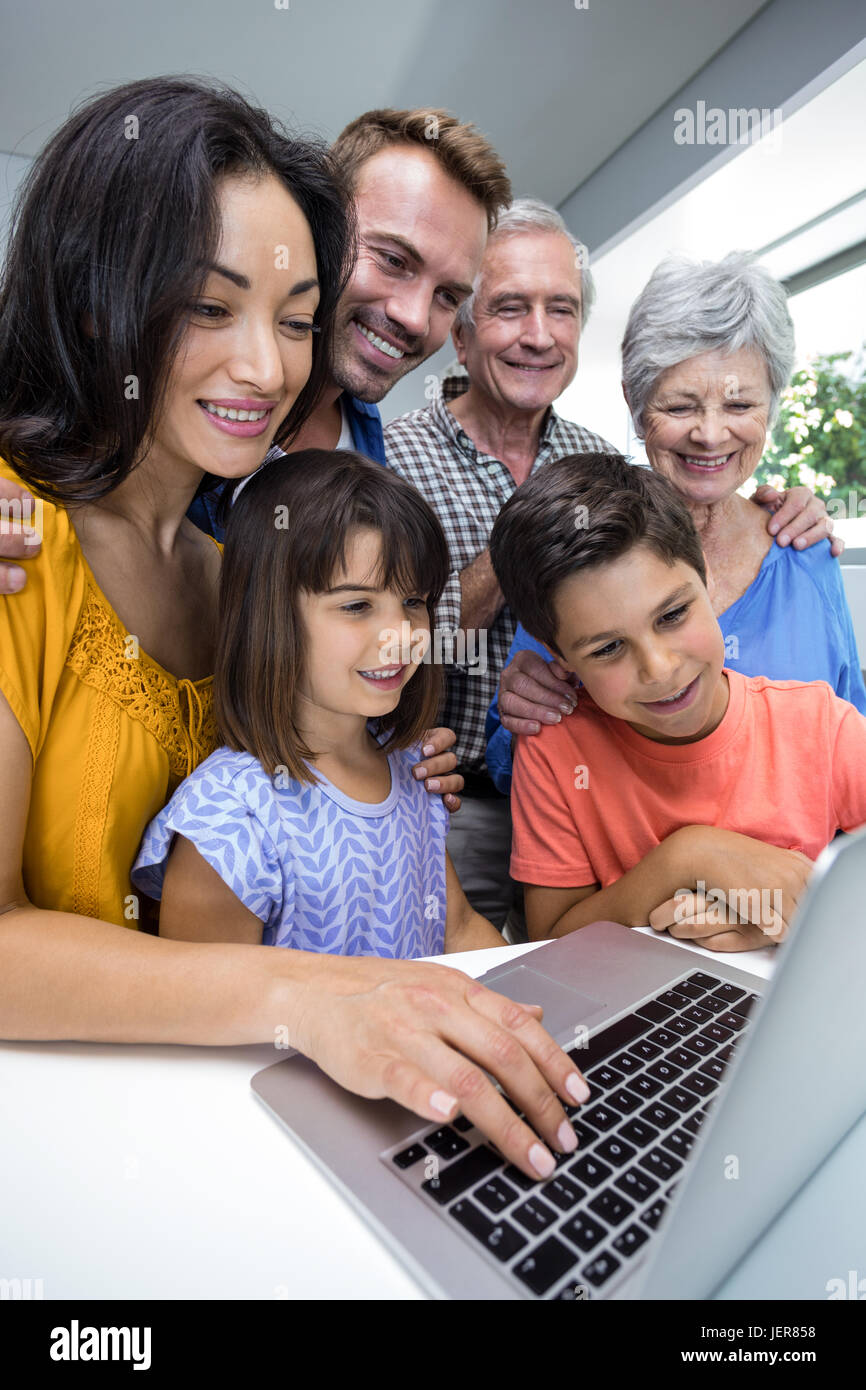 Happy family interacting using laptop Stock Photo - Alamy