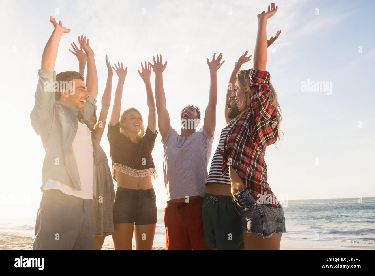 Happy friends giving high five Stock Photo - Alamy