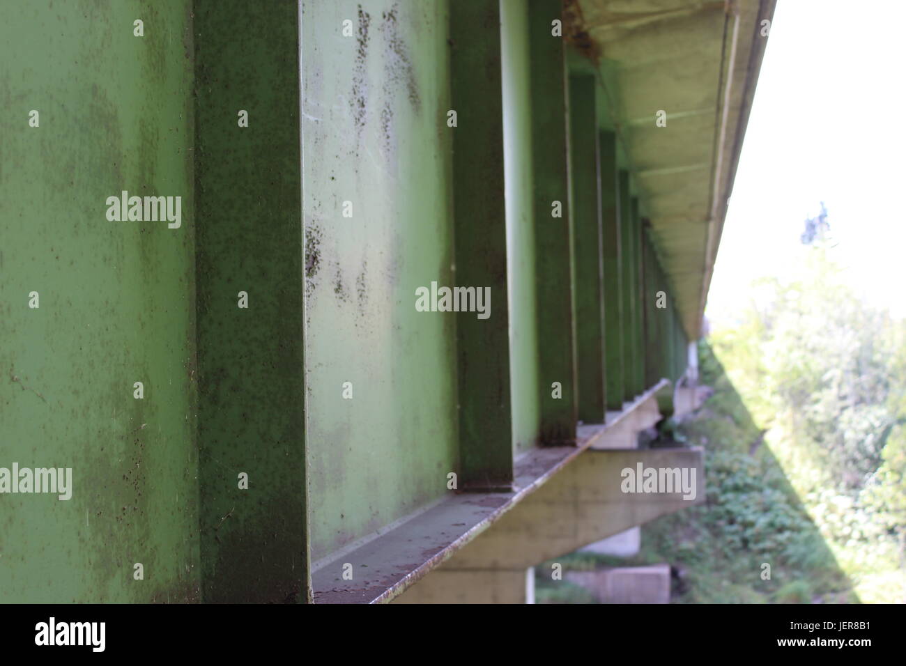 Image of an old green bridge that stretches across a river. Strange new ...