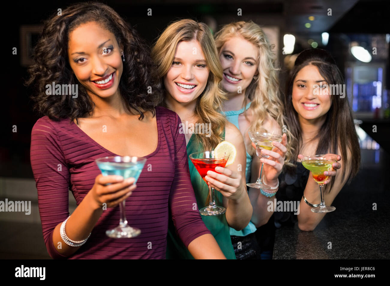 Portrait of friends having a drink Stock Photo - Alamy