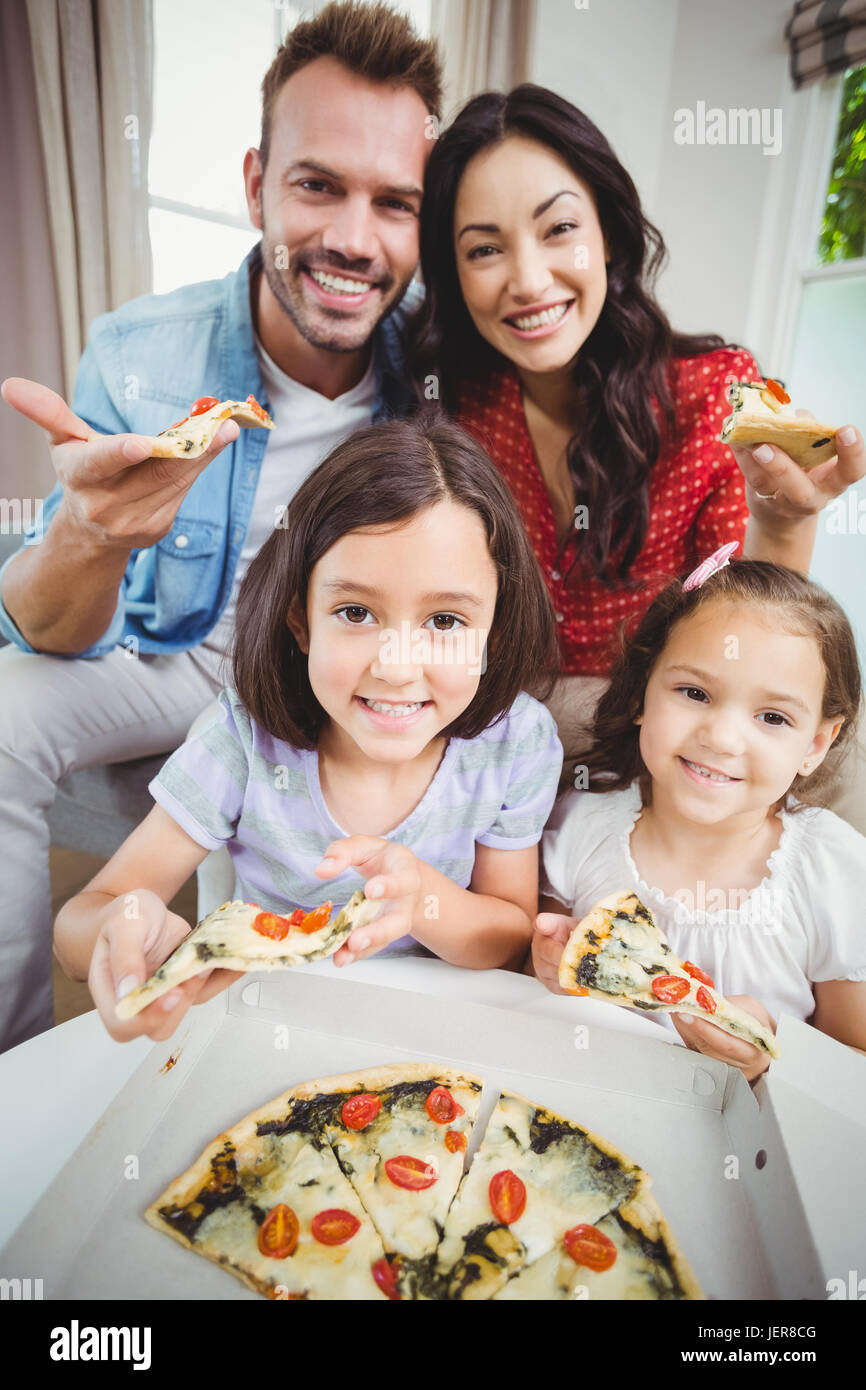 Happy family eating pizza at home Stock Photo - Alamy
