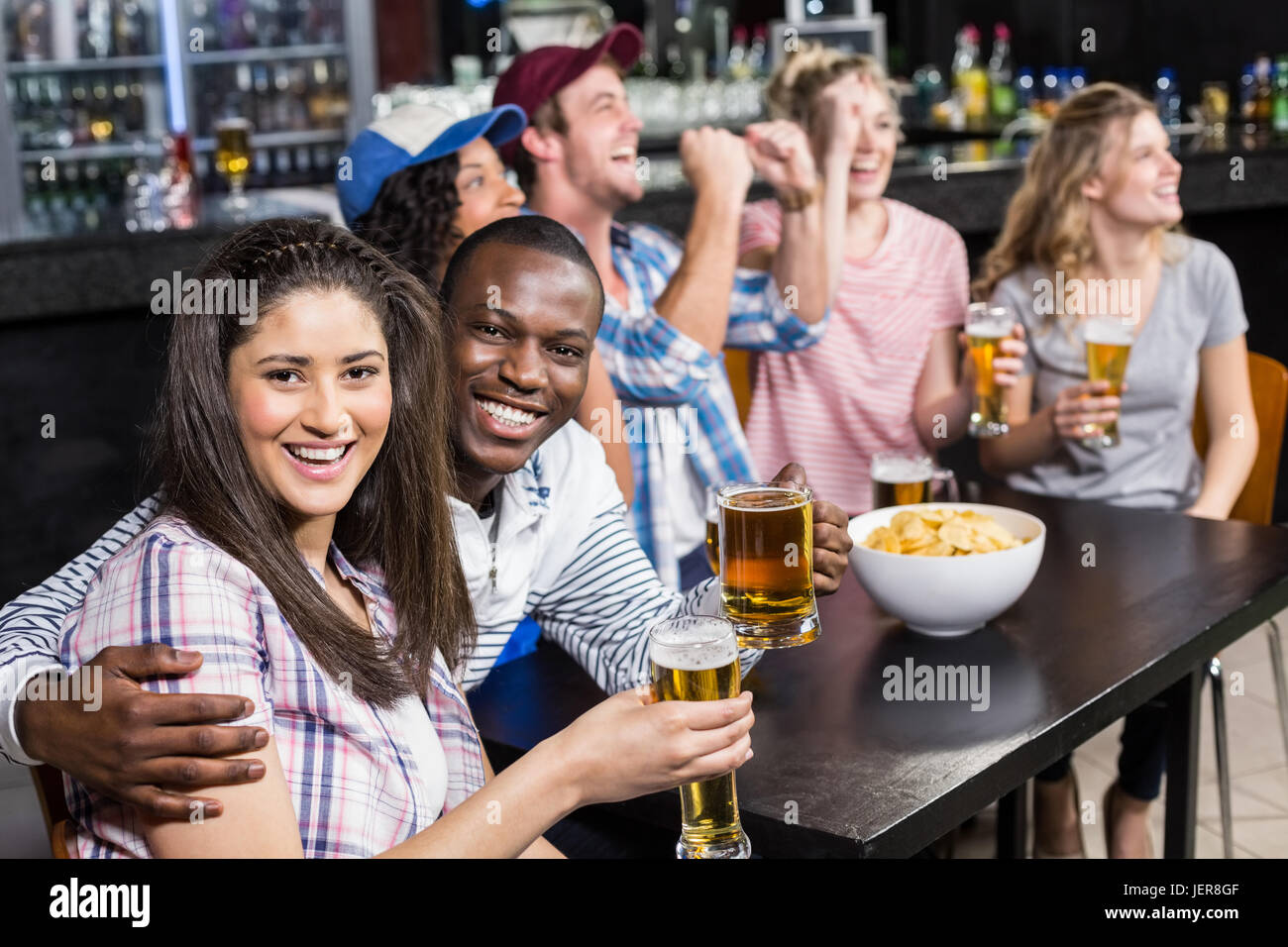 Happy friends watching sport Stock Photo - Alamy