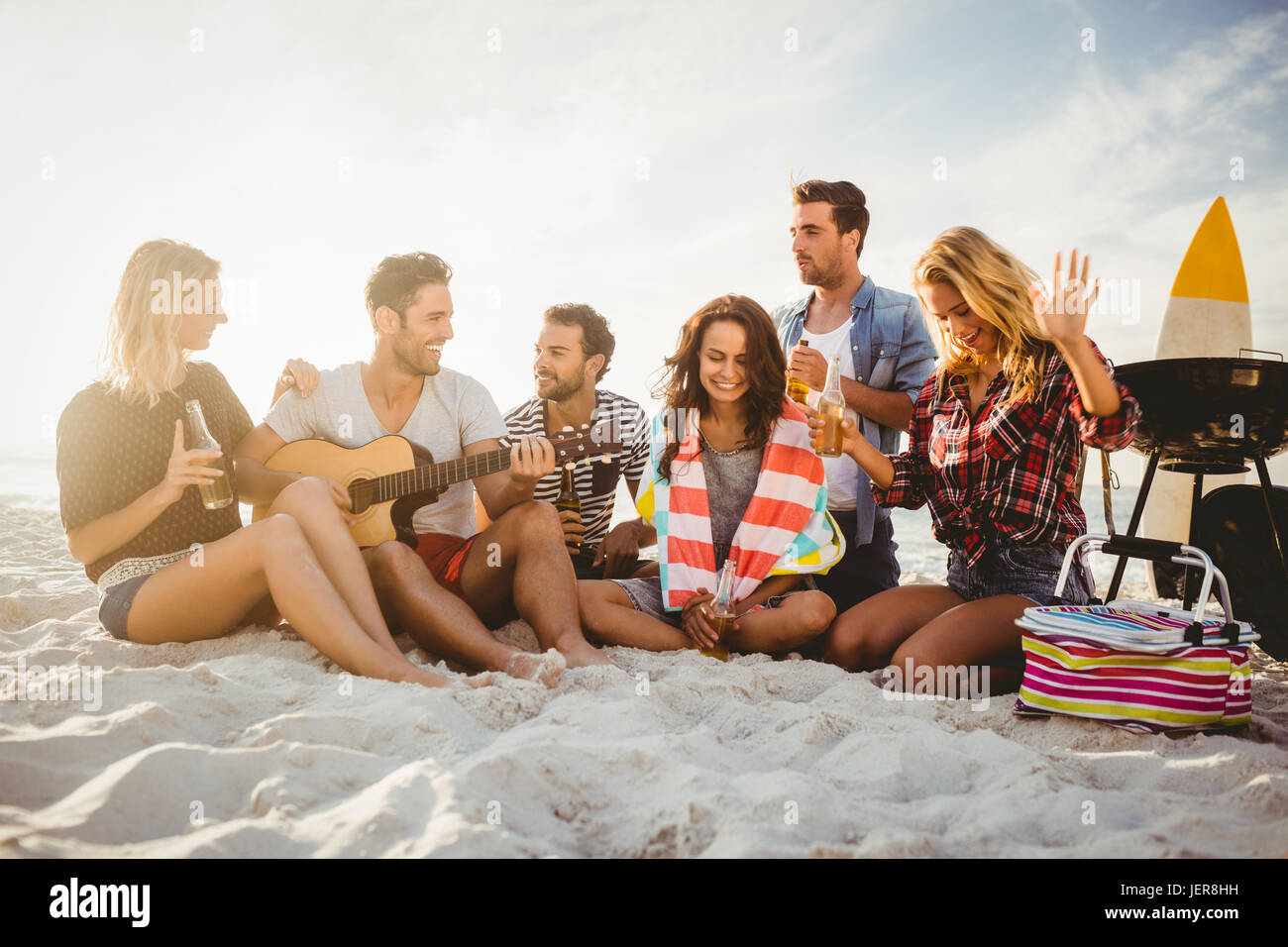 Happy friends having fun near barbecue Stock Photo - Alamy