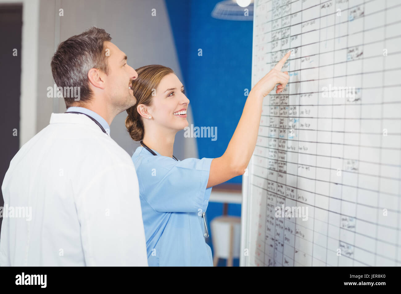 Smiling doctors looking at chart Stock Photo - Alamy