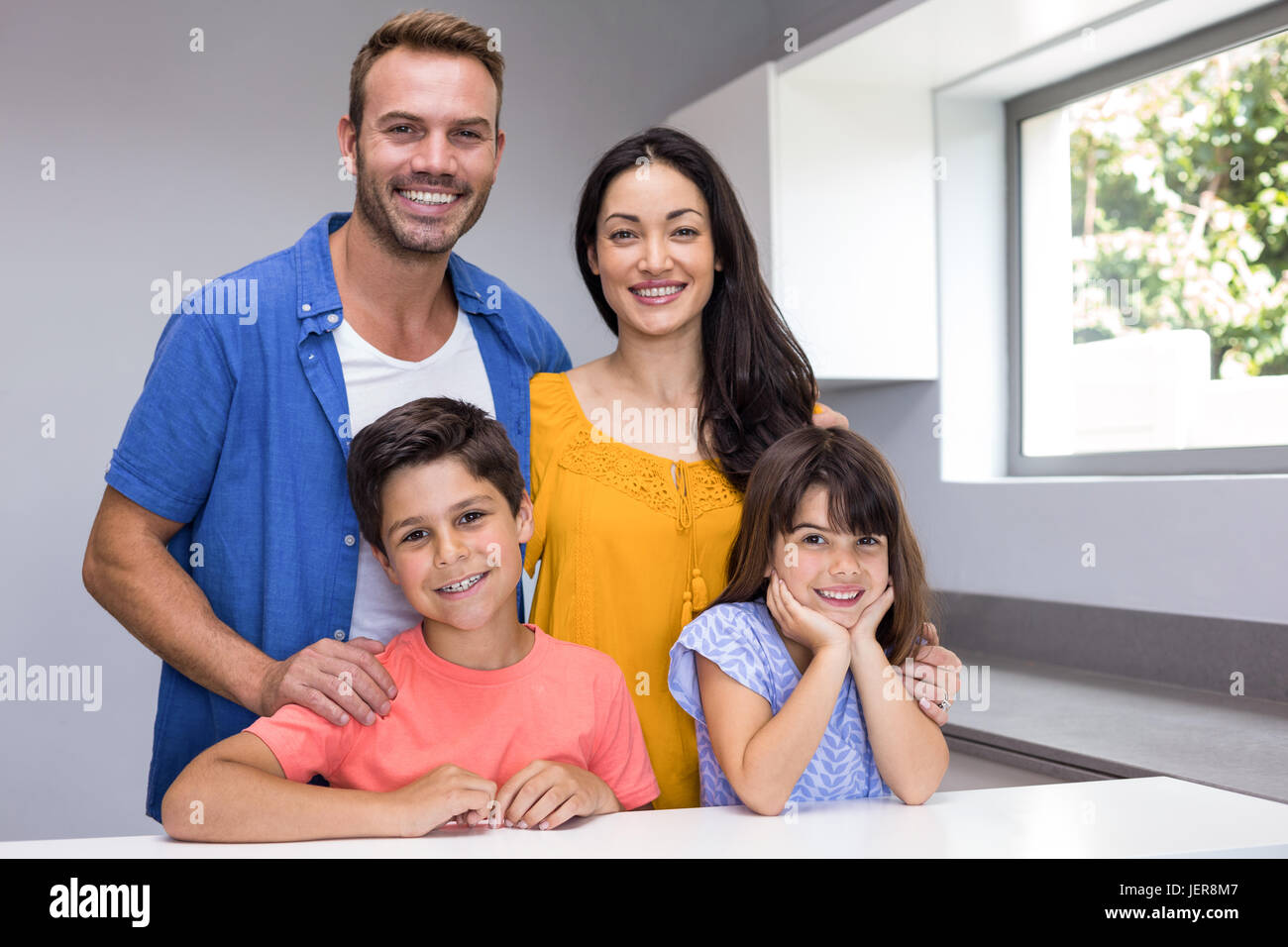 Happy family in living room Stock Photo - Alamy