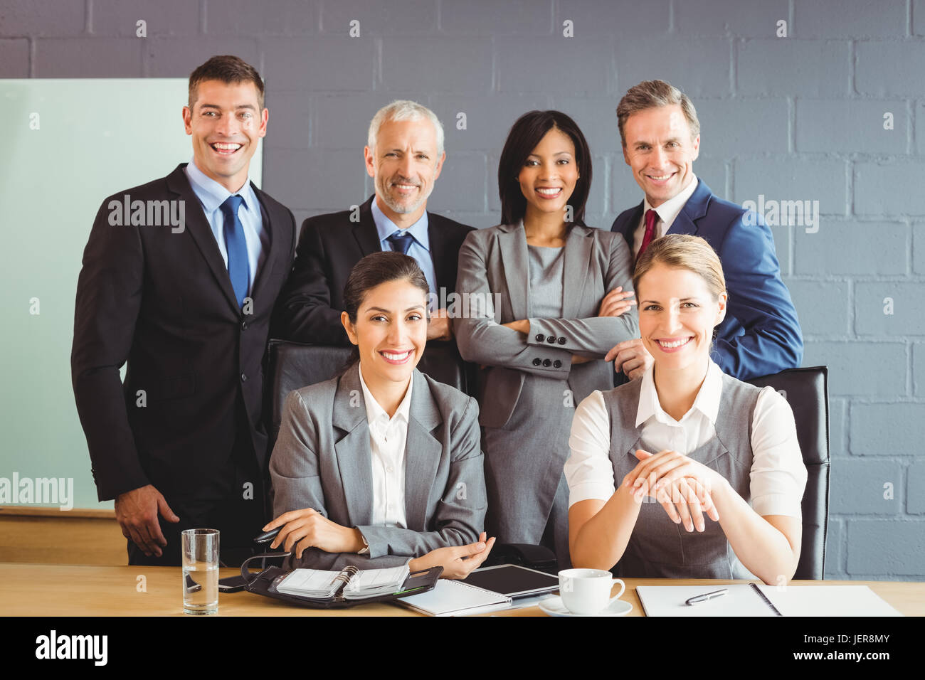 Businesspeople smiling in conference room Stock Photo - Alamy