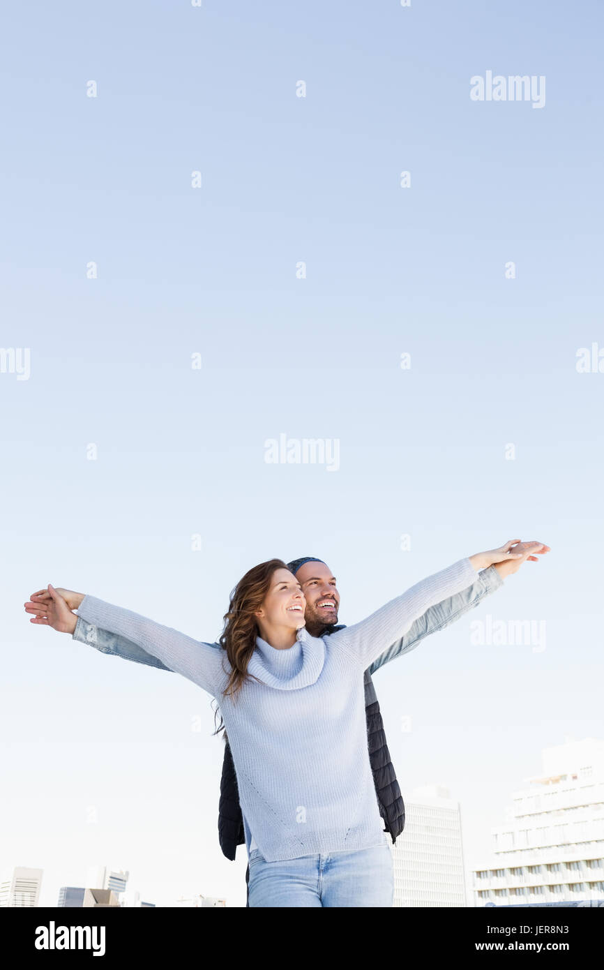 Couple standing with arms outstretched Stock Photo - Alamy