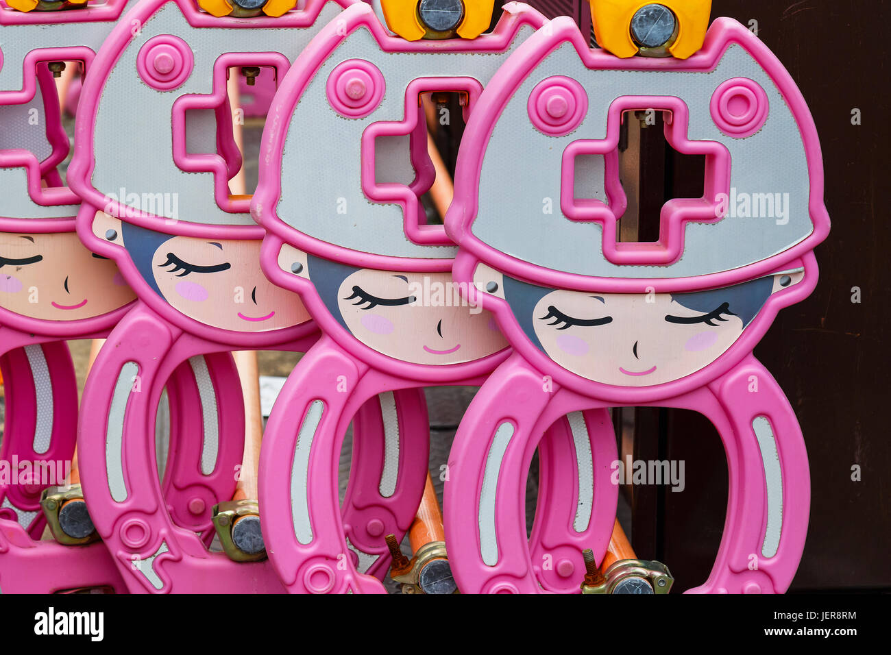 Row of Japanese construction barrier designed in cute cartoon character ...