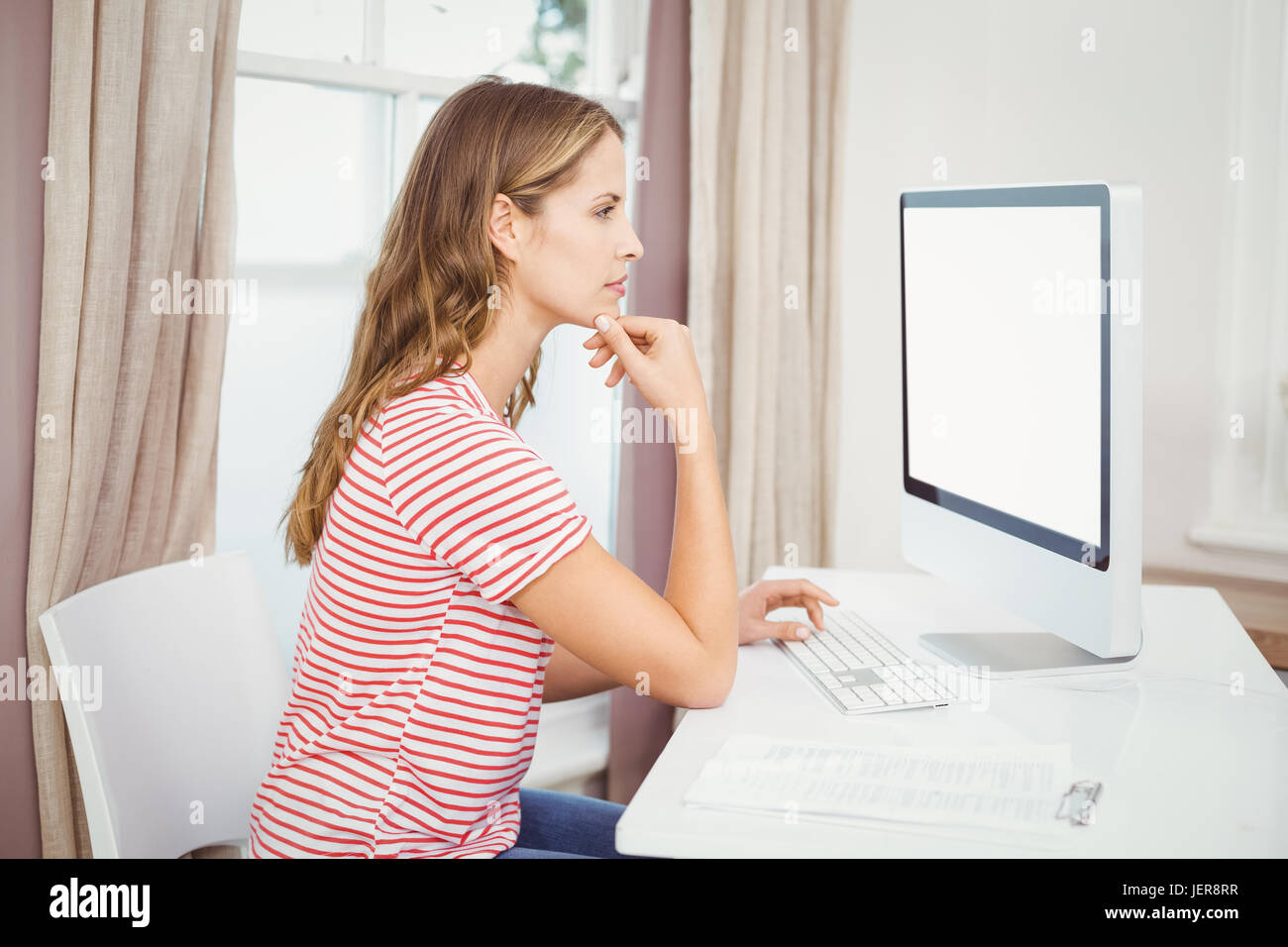 Beautiful woman using computer at home Stock Photo - Alamy