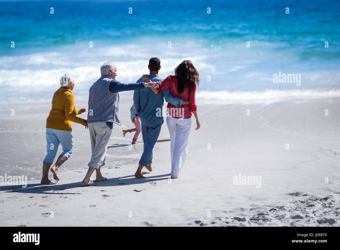 Happy family walking together Stock Photo - Alamy