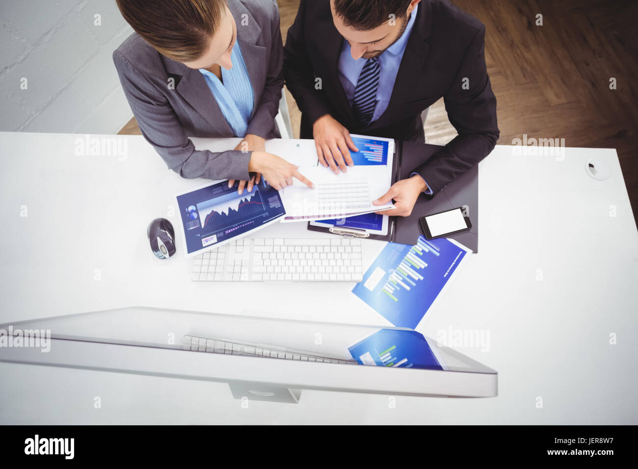 Business people discussing over documents Stock Photo - Alamy