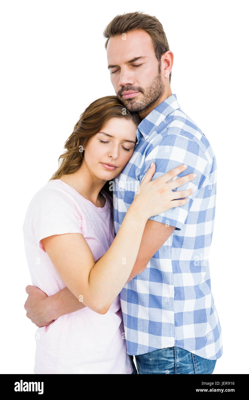 Happy young couple cuddling each other Stock Photo - Alamy