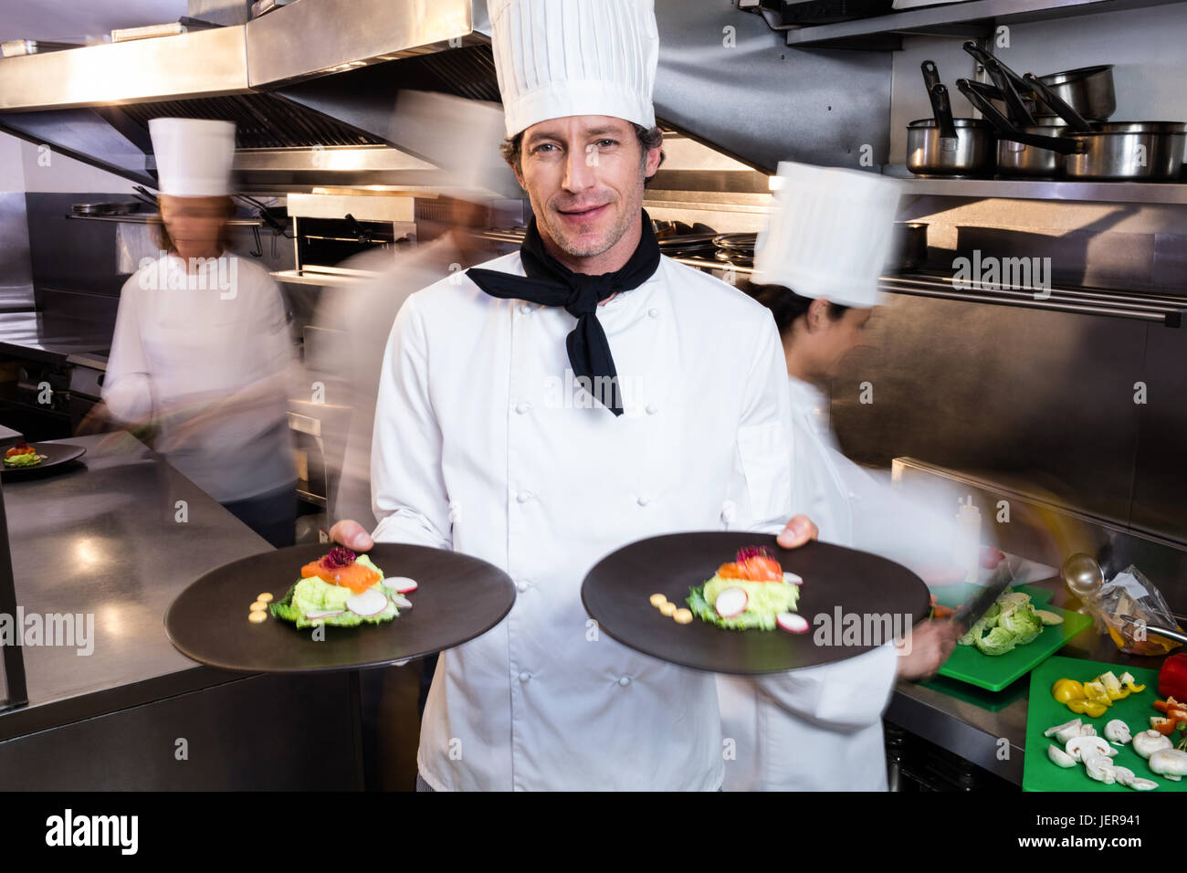 Happy head chef presenting his food plates Stock Photo - Alamy