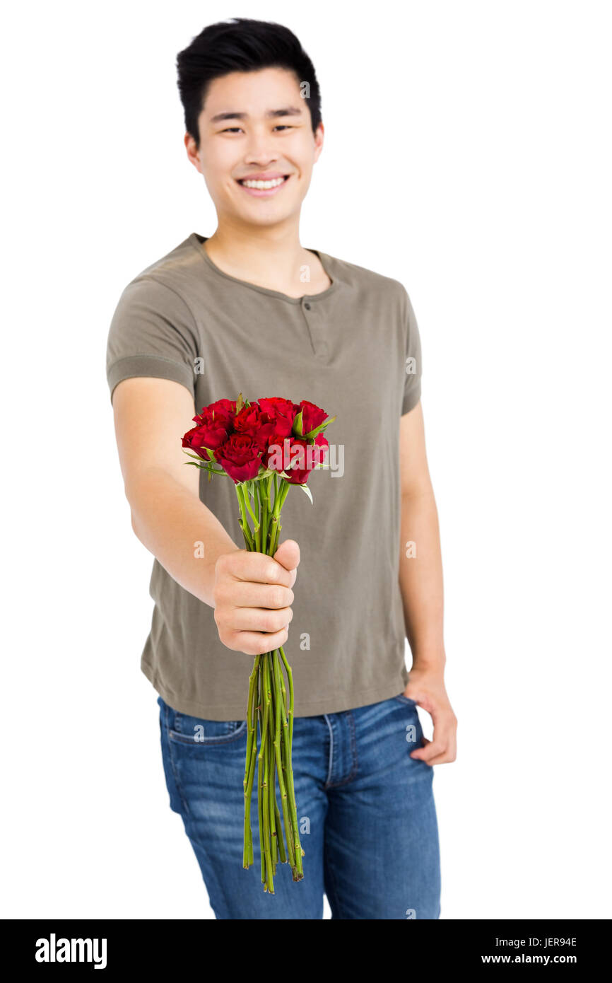 Happy young man holding bunch of red roses Stock Photo - Alamy