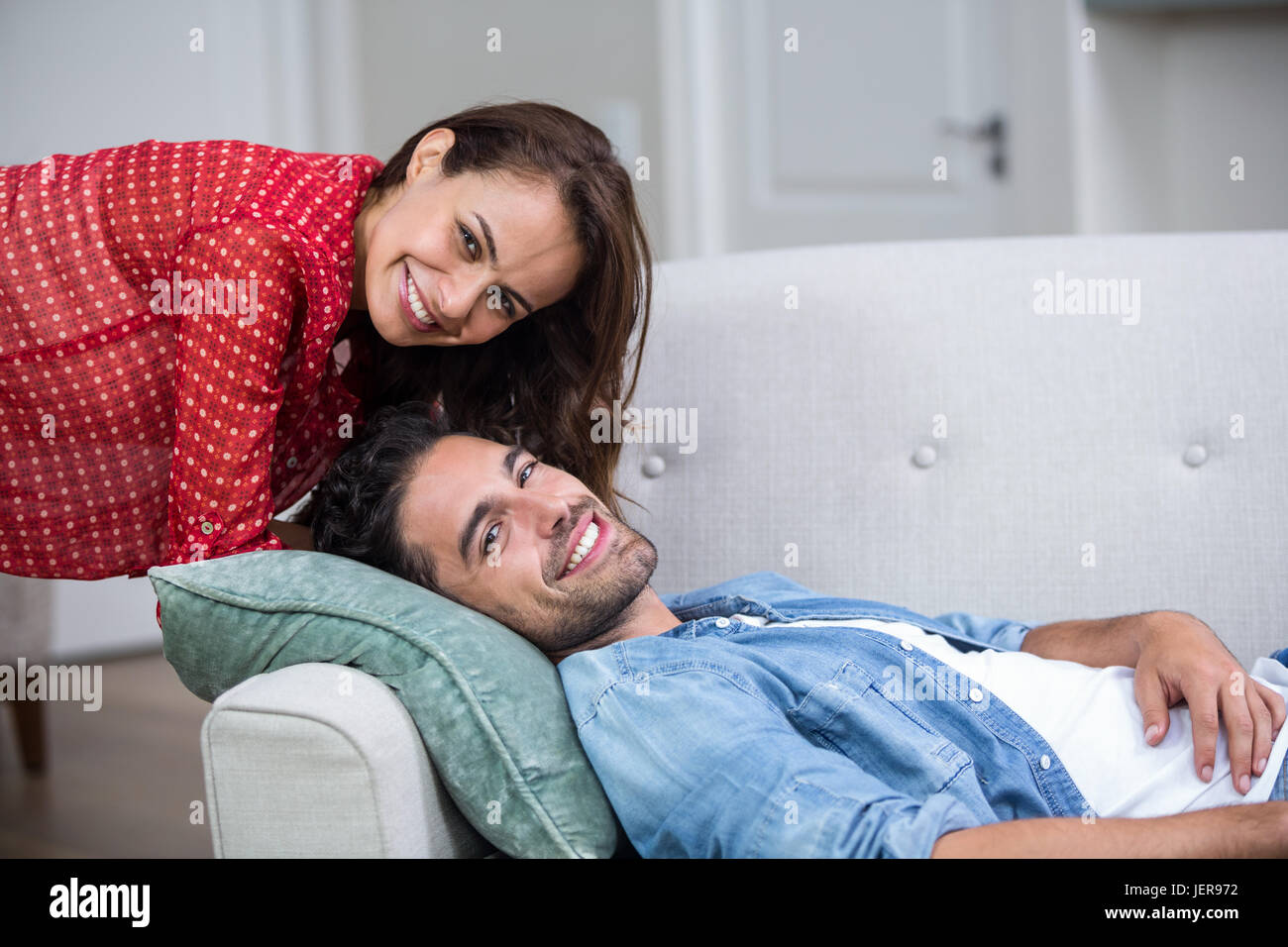 Happy romantic couple relaxing on sofa Stock Photo - Alamy