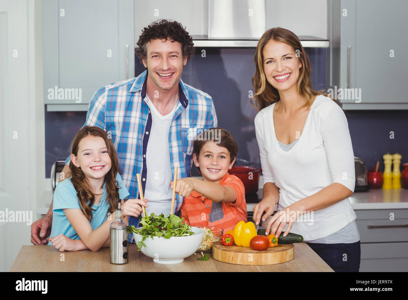 Portrait of happy family in kitchen Stock Photo - Alamy