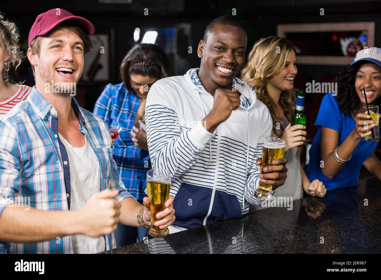 Happy friends watching sport Stock Photo - Alamy