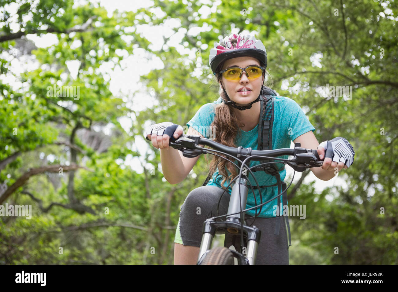 Woman riding her bike Stock Photo - Alamy