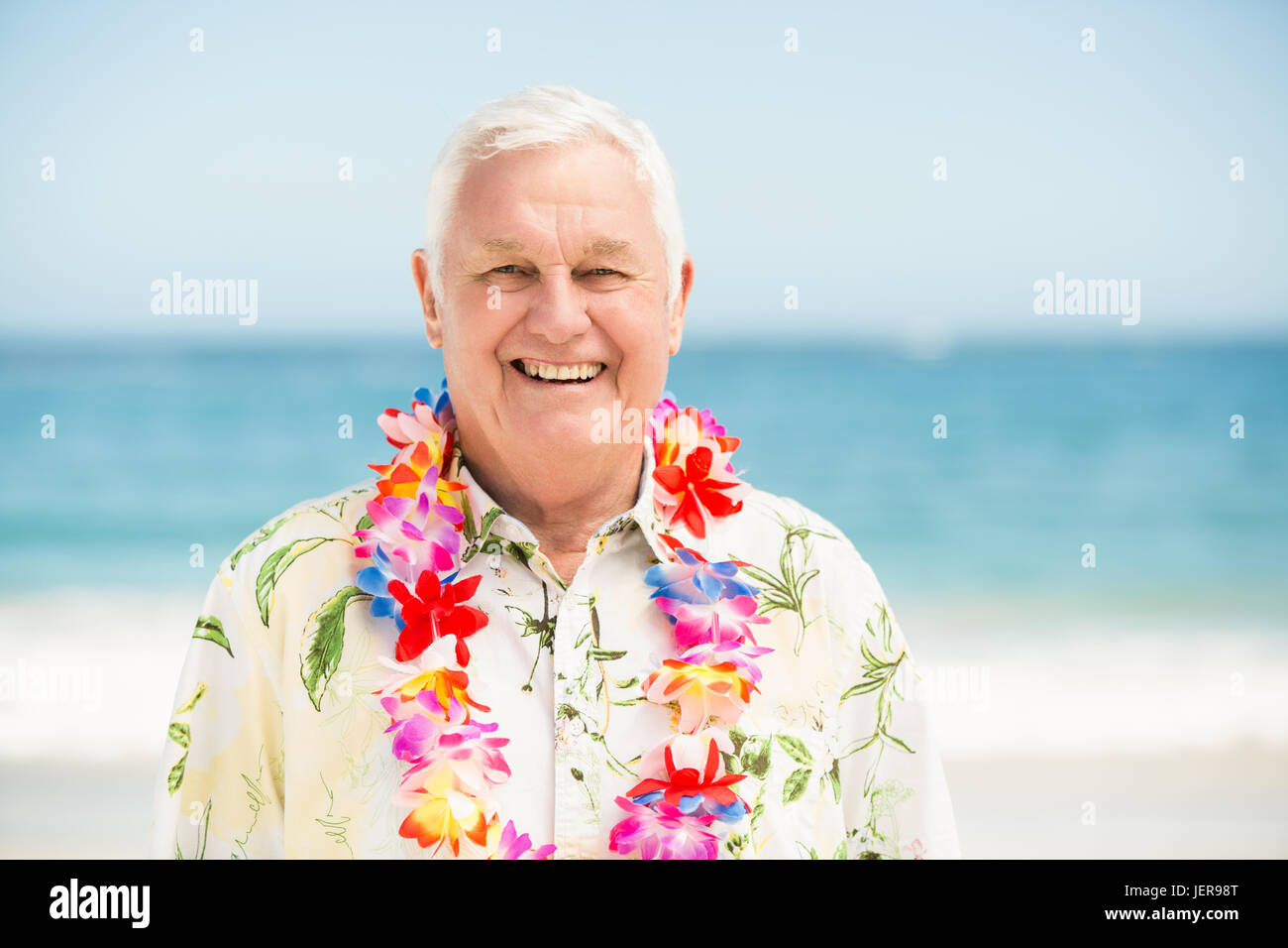 Senior man standing at the beach Stock Photo - Alamy