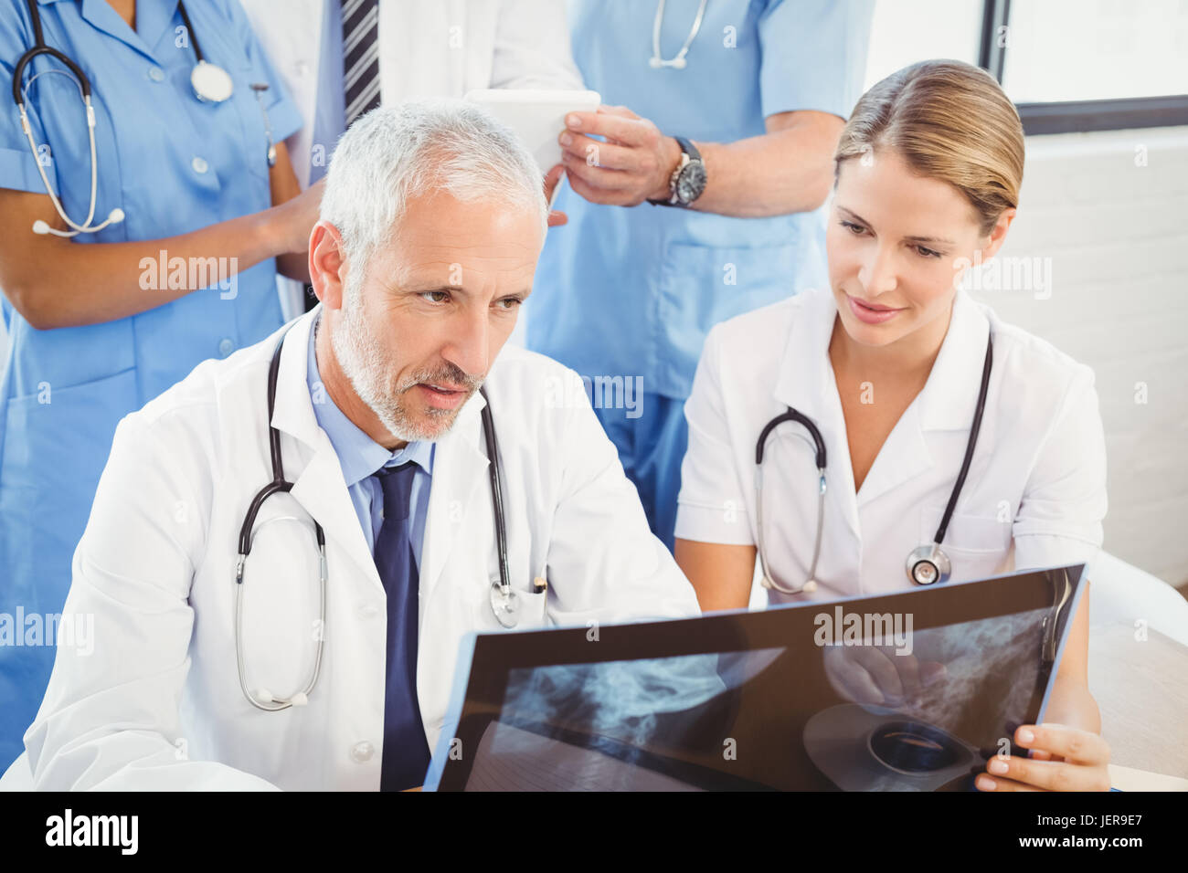 Two doctors examining an x-ray report Stock Photo - Alamy