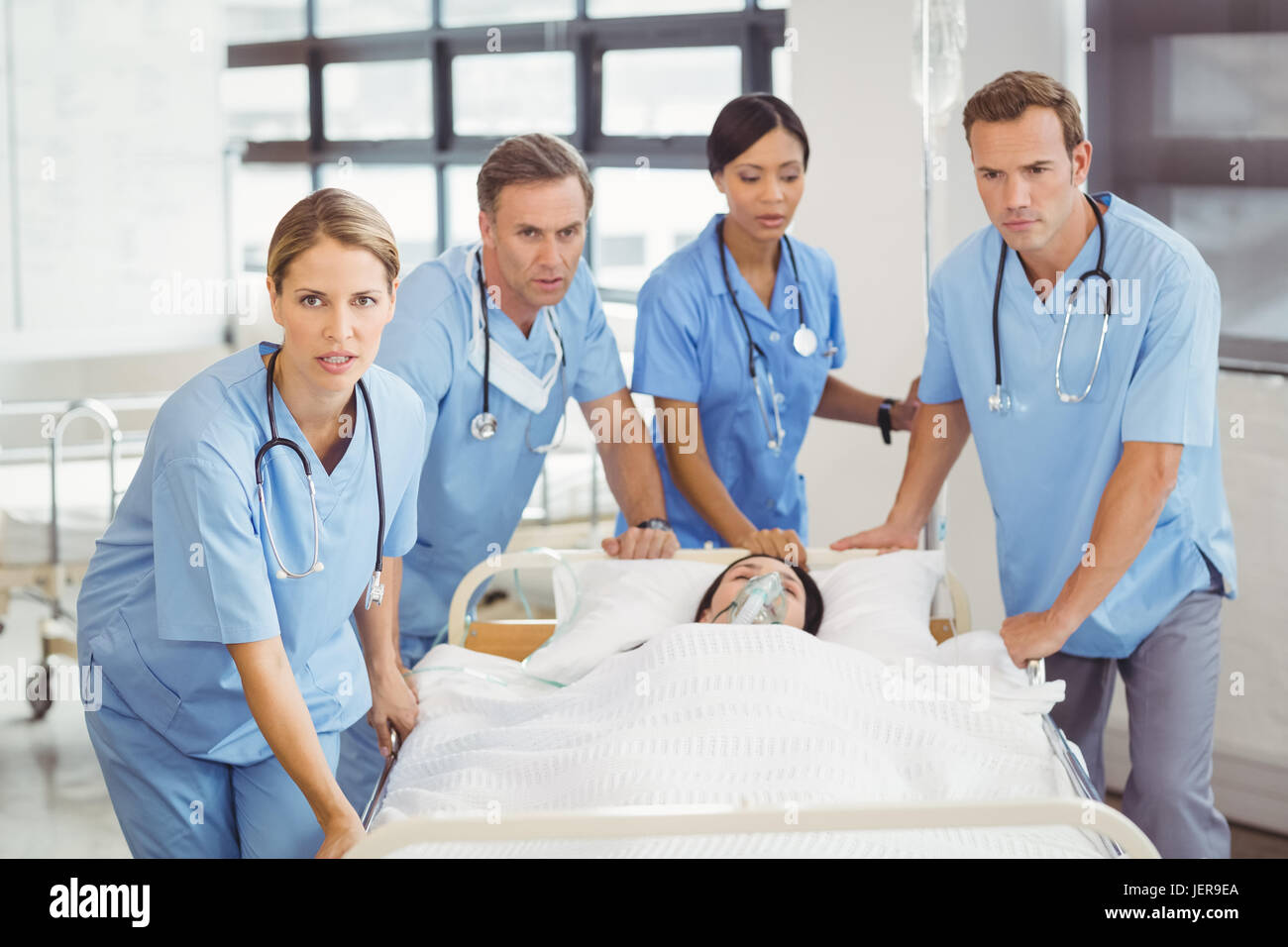 Group of doctors carrying woman patient Stock Photo - Alamy