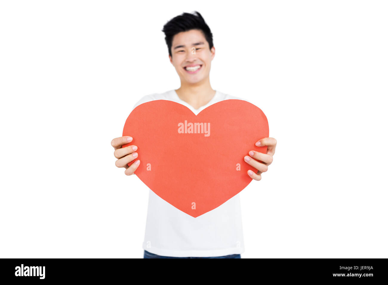 Young man holding heart shape Stock Photo - Alamy