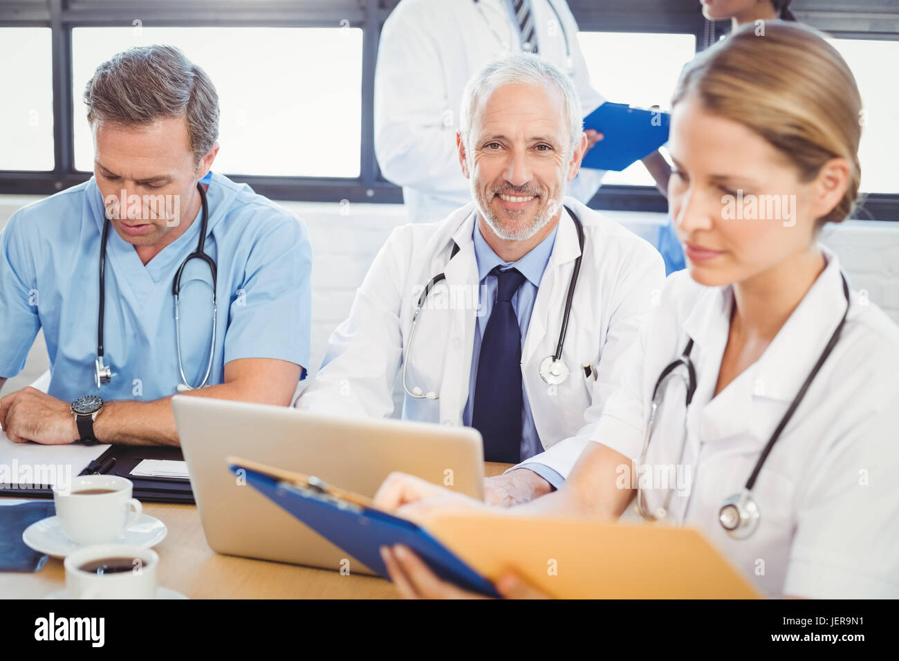 Male doctor using laptop in conference room Stock Photo - Alamy