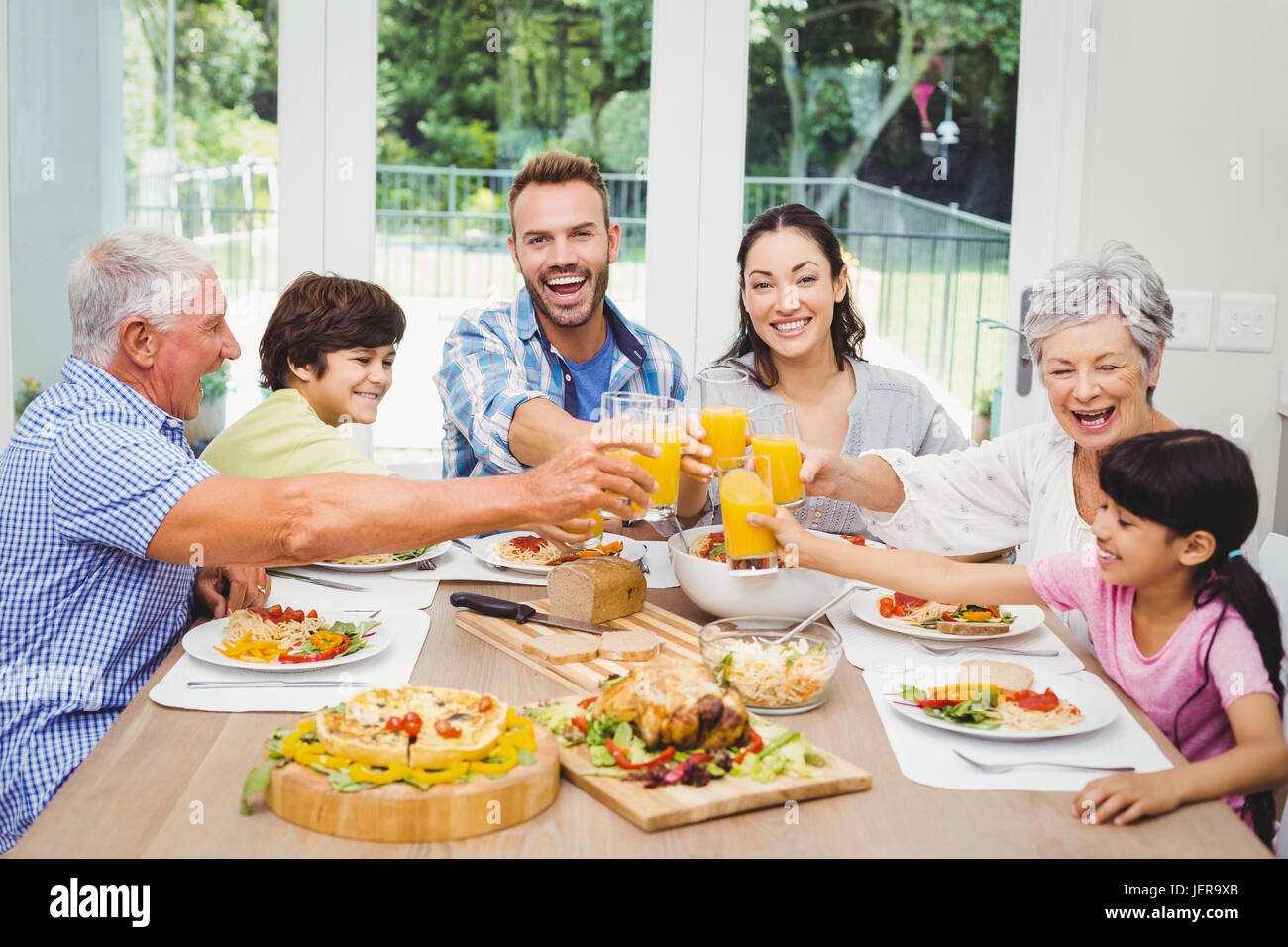 Smiling family toasting juice Stock Photo - Alamy