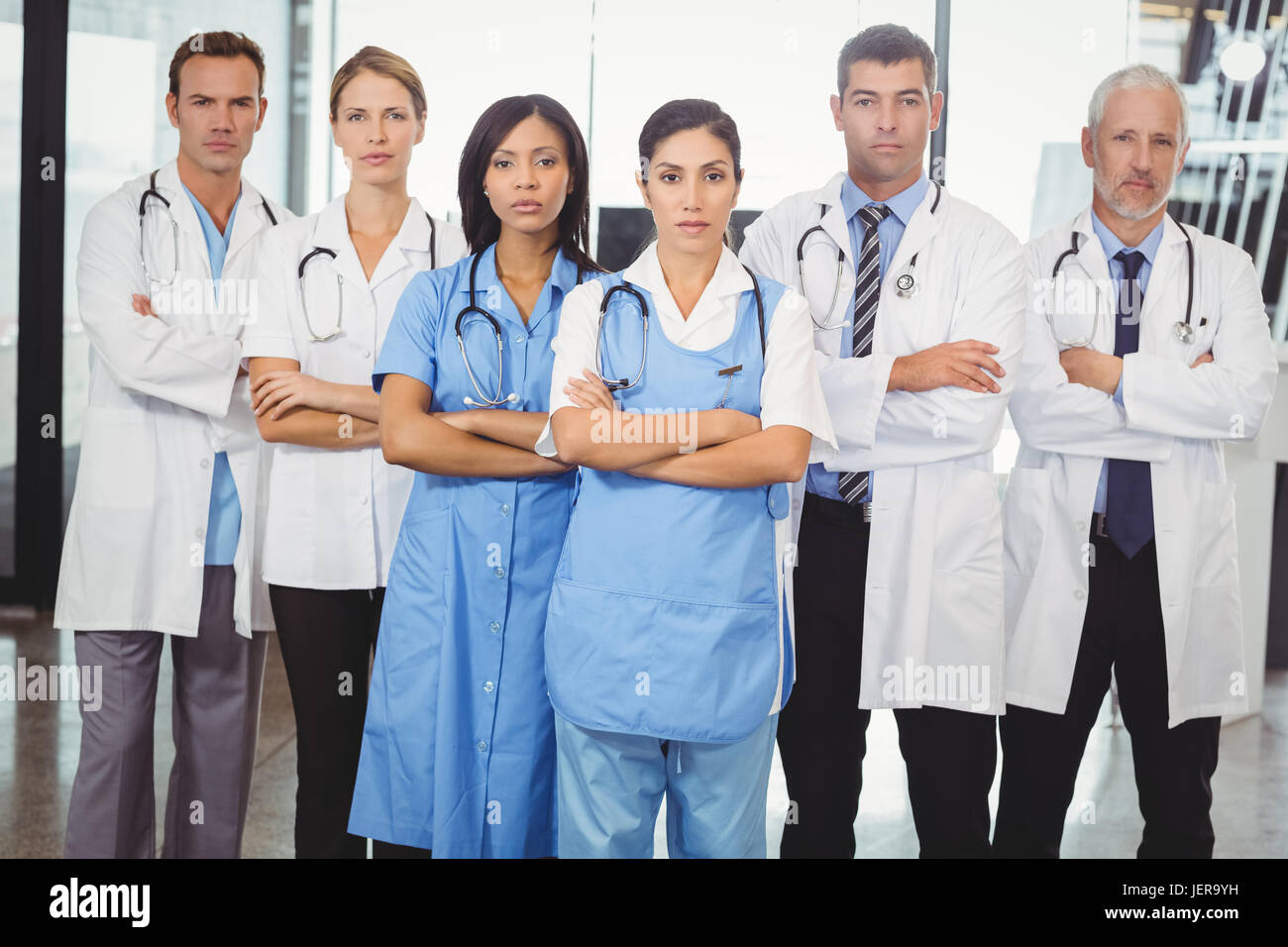 Medical team standing with arms crossed Stock Photo - Alamy