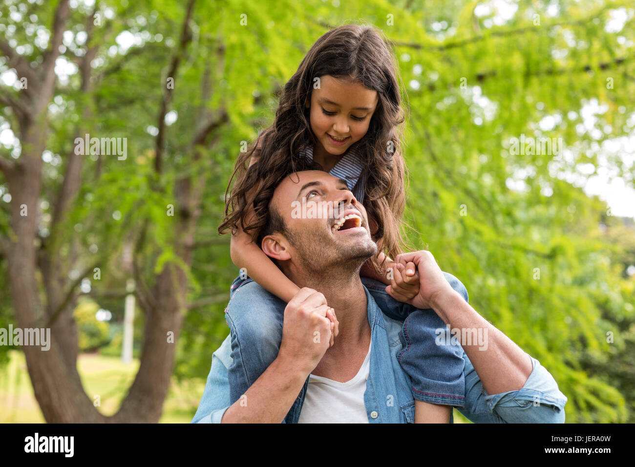 Father carrying daughter on his shoulders Stock Photo - Alamy
