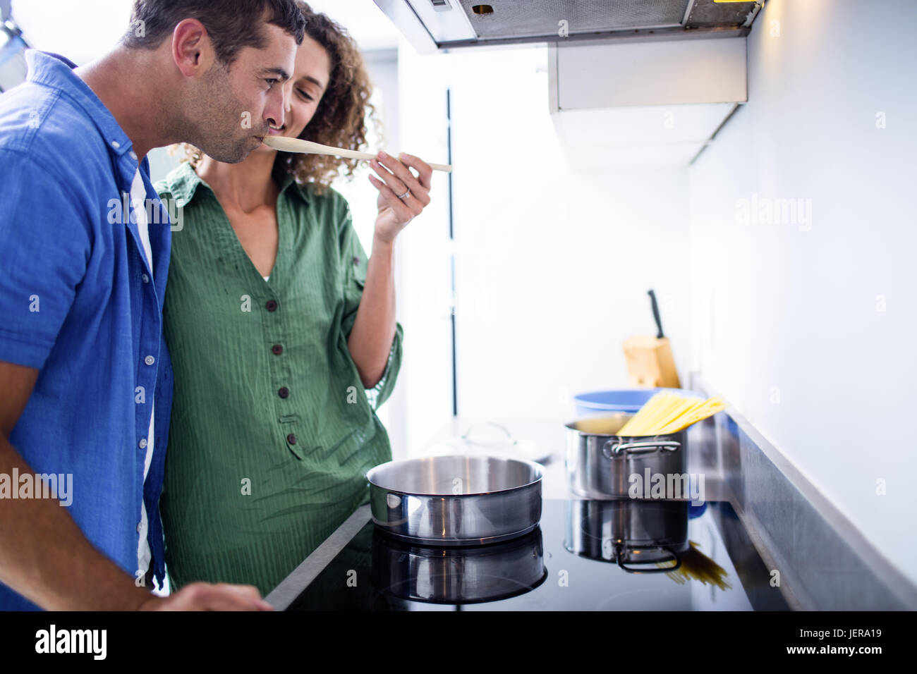 Man tasting food from pot Stock Photo - Alamy