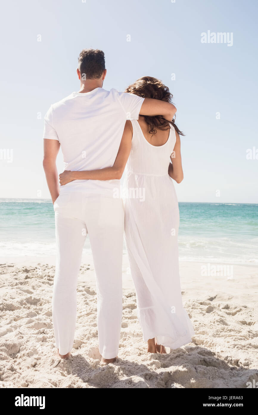 Young couple looking at the beach Stock Photo - Alamy
