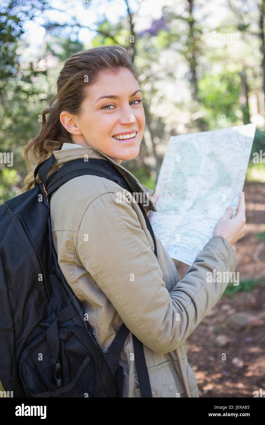 Smiling woman holding the map Stock Photo - Alamy