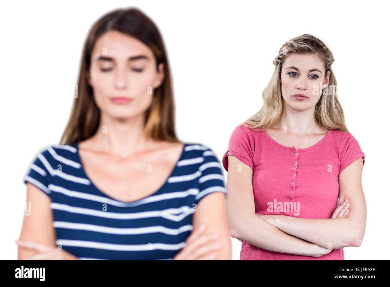 Upset female friends with arms crossed Stock Photo - Alamy