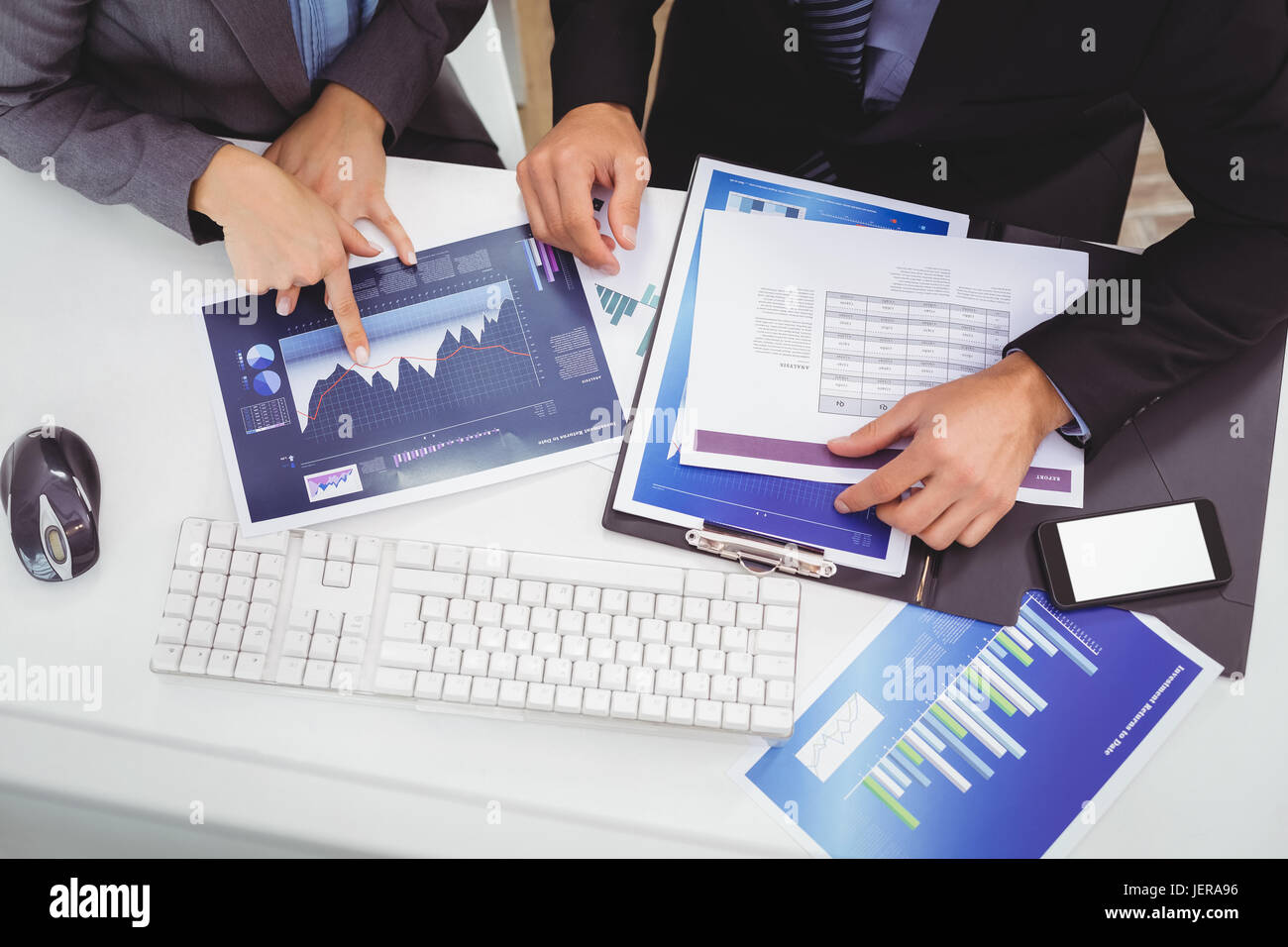 Executives discussing over graph chart hi-res stock photography and ...