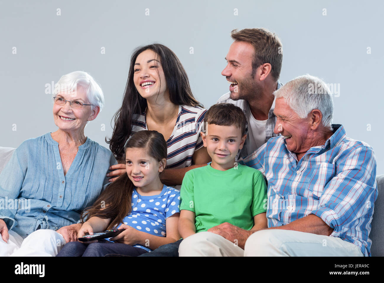 Happy family watching television Stock Photo - Alamy